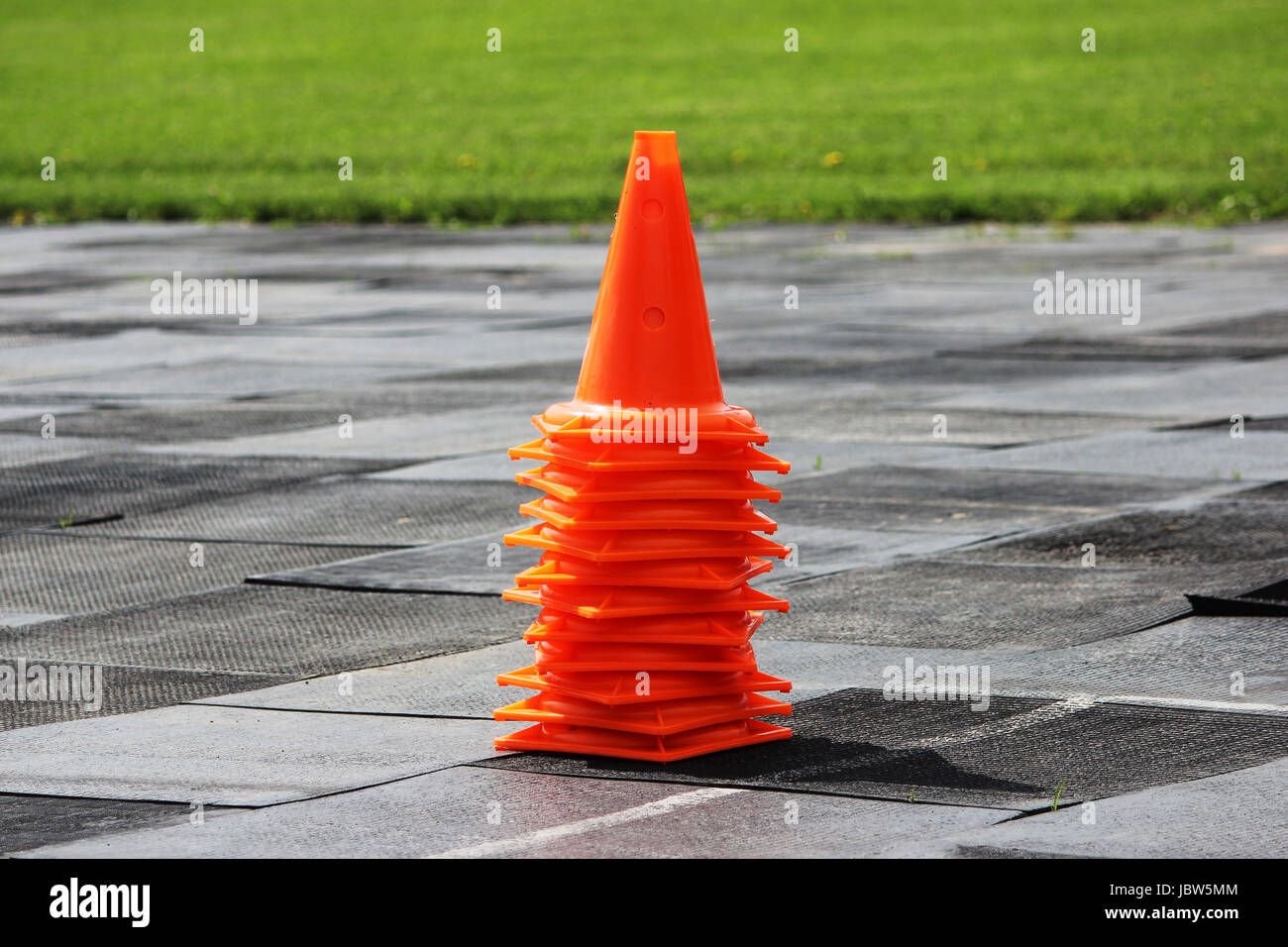 Plastic orange signal cones stand at the stadium in preparation for the ...