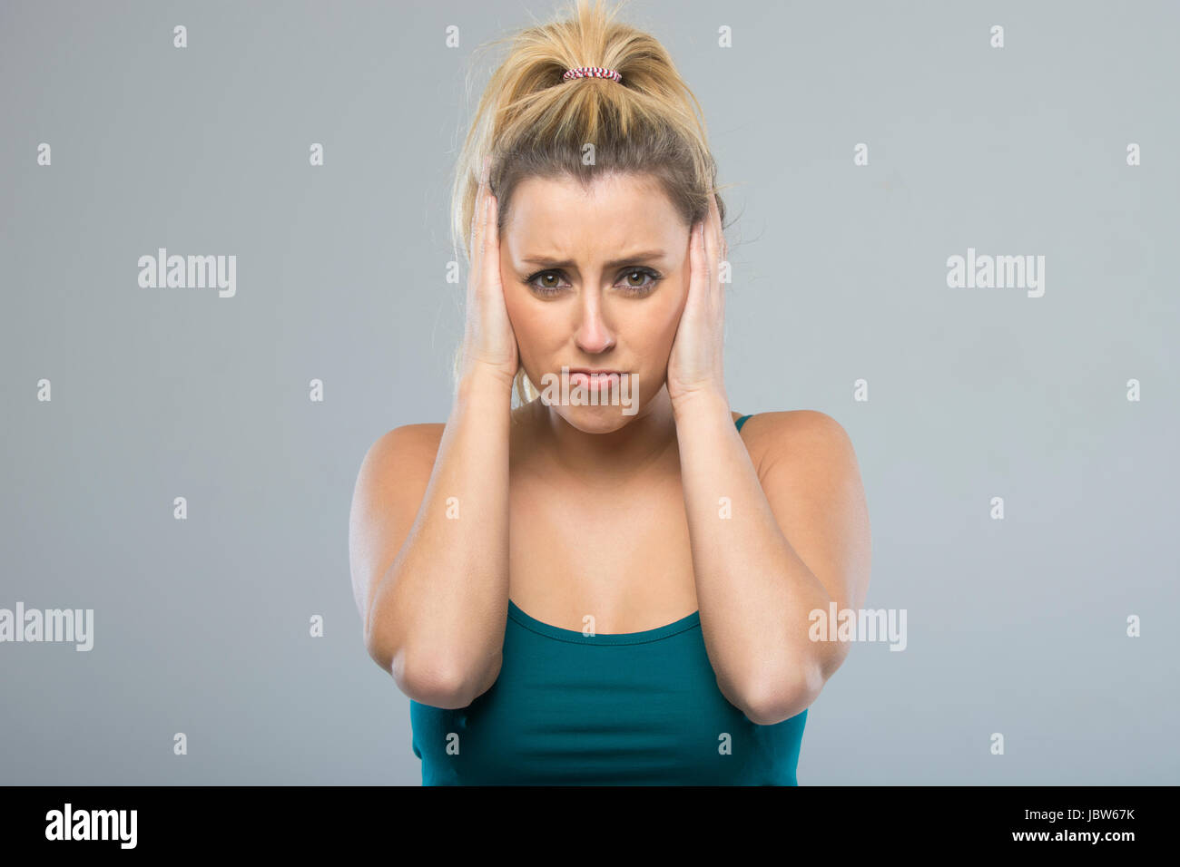 Upset woman hands on face Stock Photo - Alamy