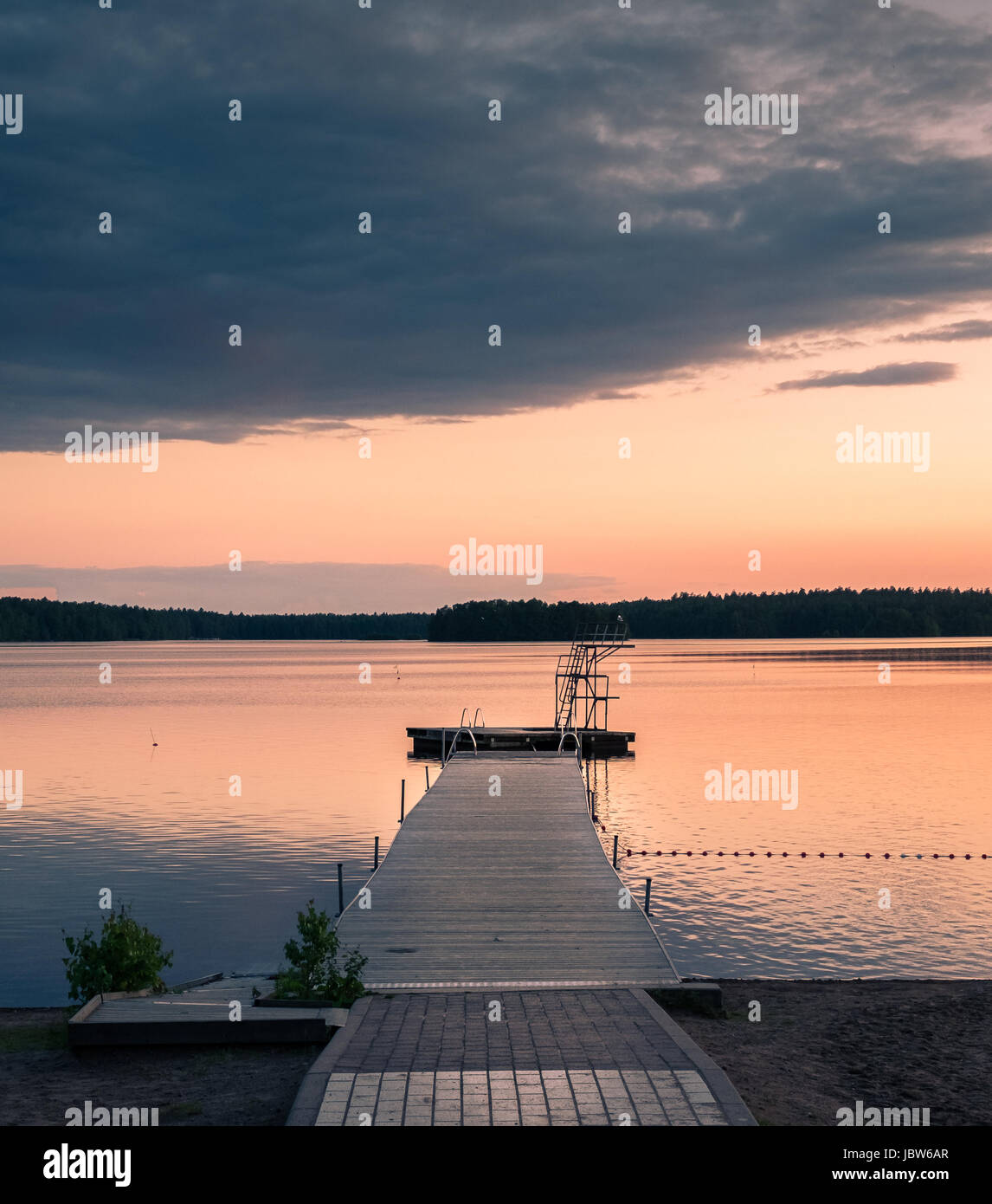 Landscape with pier and sunset at summer evening in the lake Stock ...
