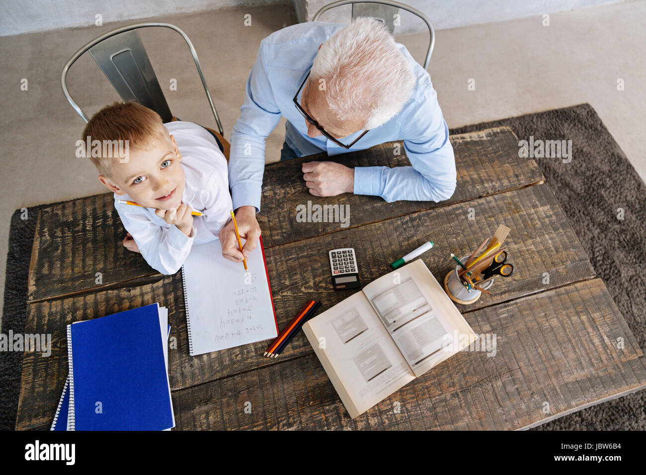 Two generations studying math together Stock Photo - Alamy