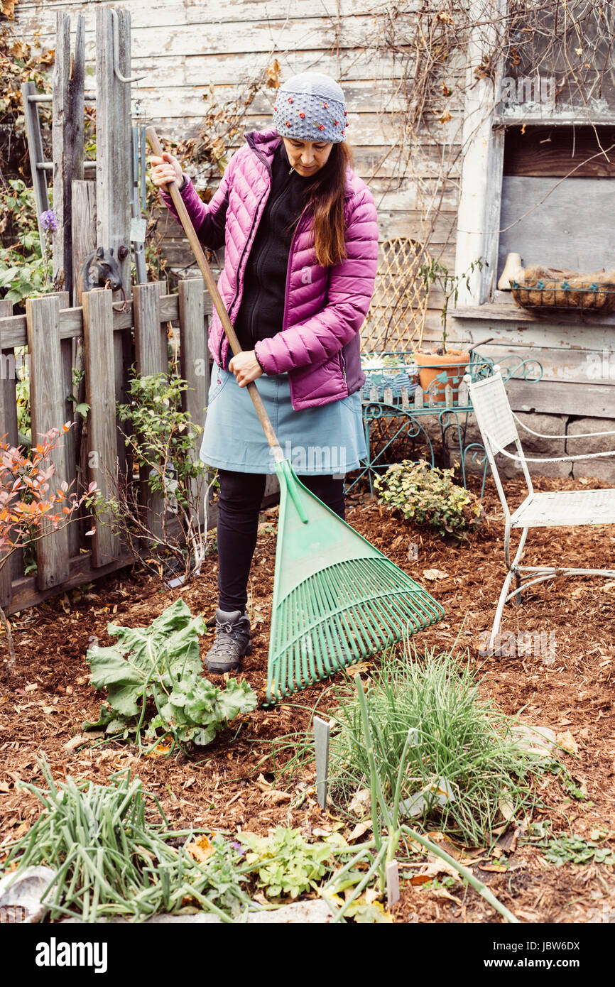 Senior woman standing rake hi-res stock photography and images - Alamy