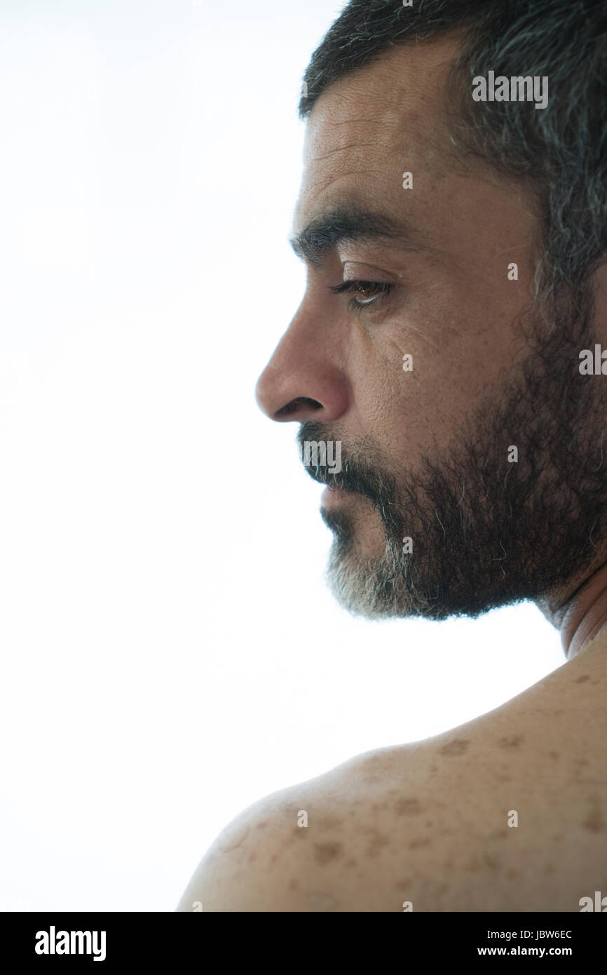 Serious middle eastern man looking away thinking Stock Photo - Alamy