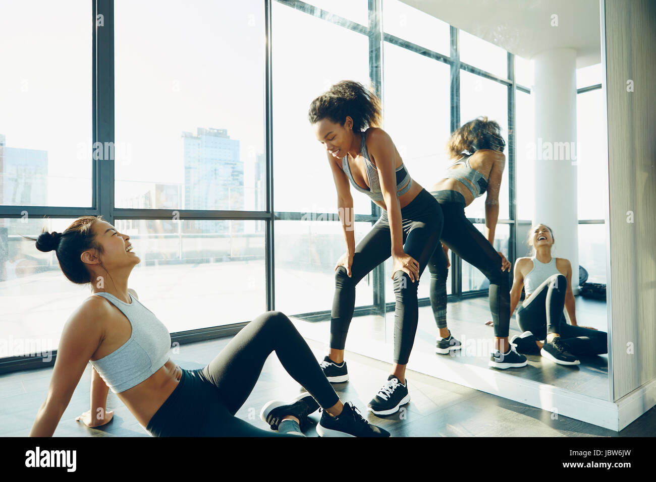 Two young women in gym, taking a break from workout Stock Photo - Alamy