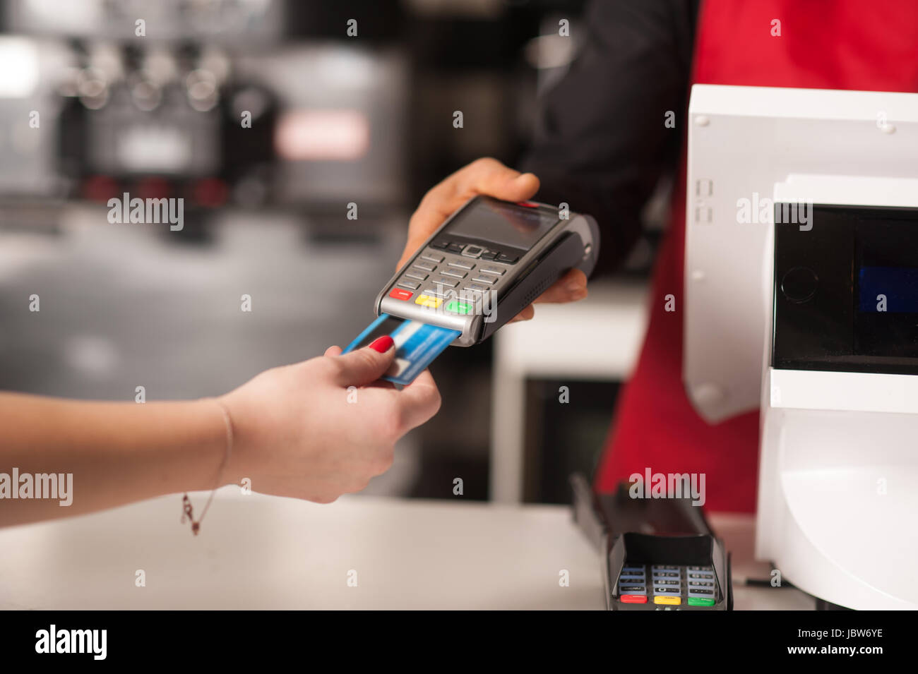Staff receiving payment by credit card in restaurant Stock Photo - Alamy