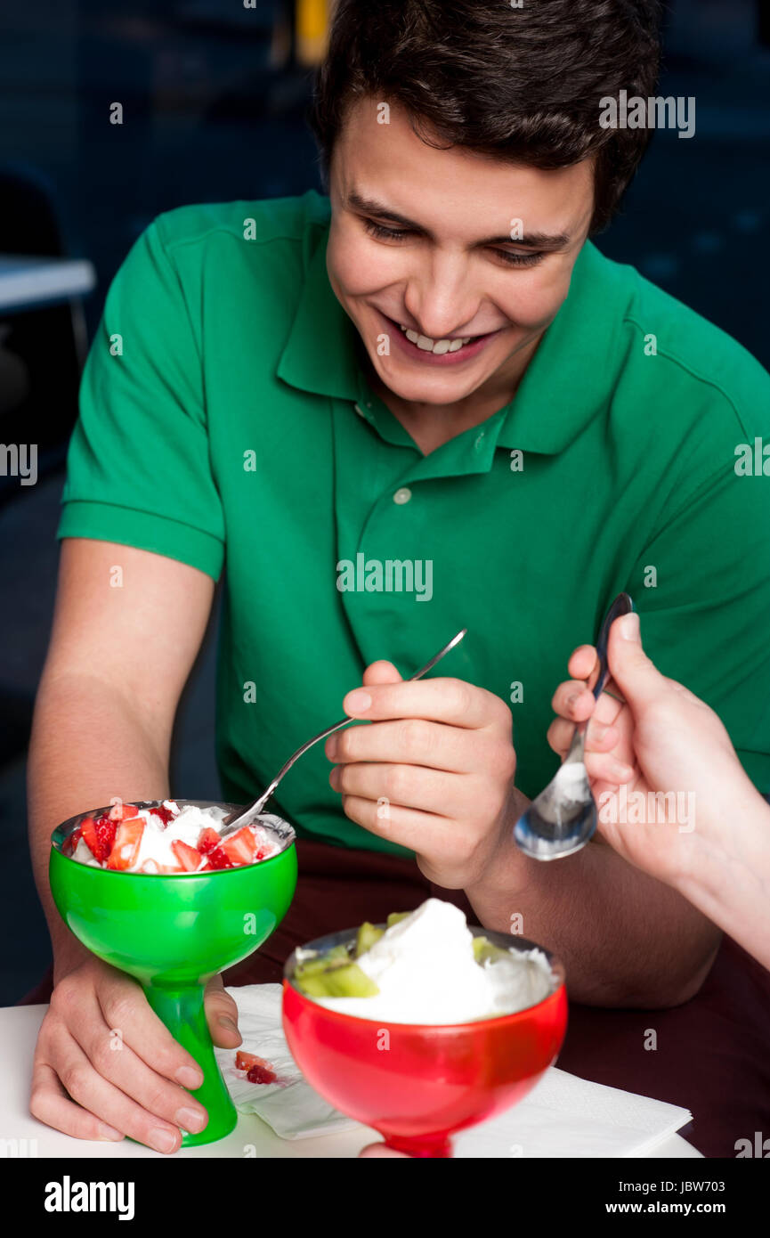 Smiling teen enjoying yummy ice-cream Stock Photo - Alamy