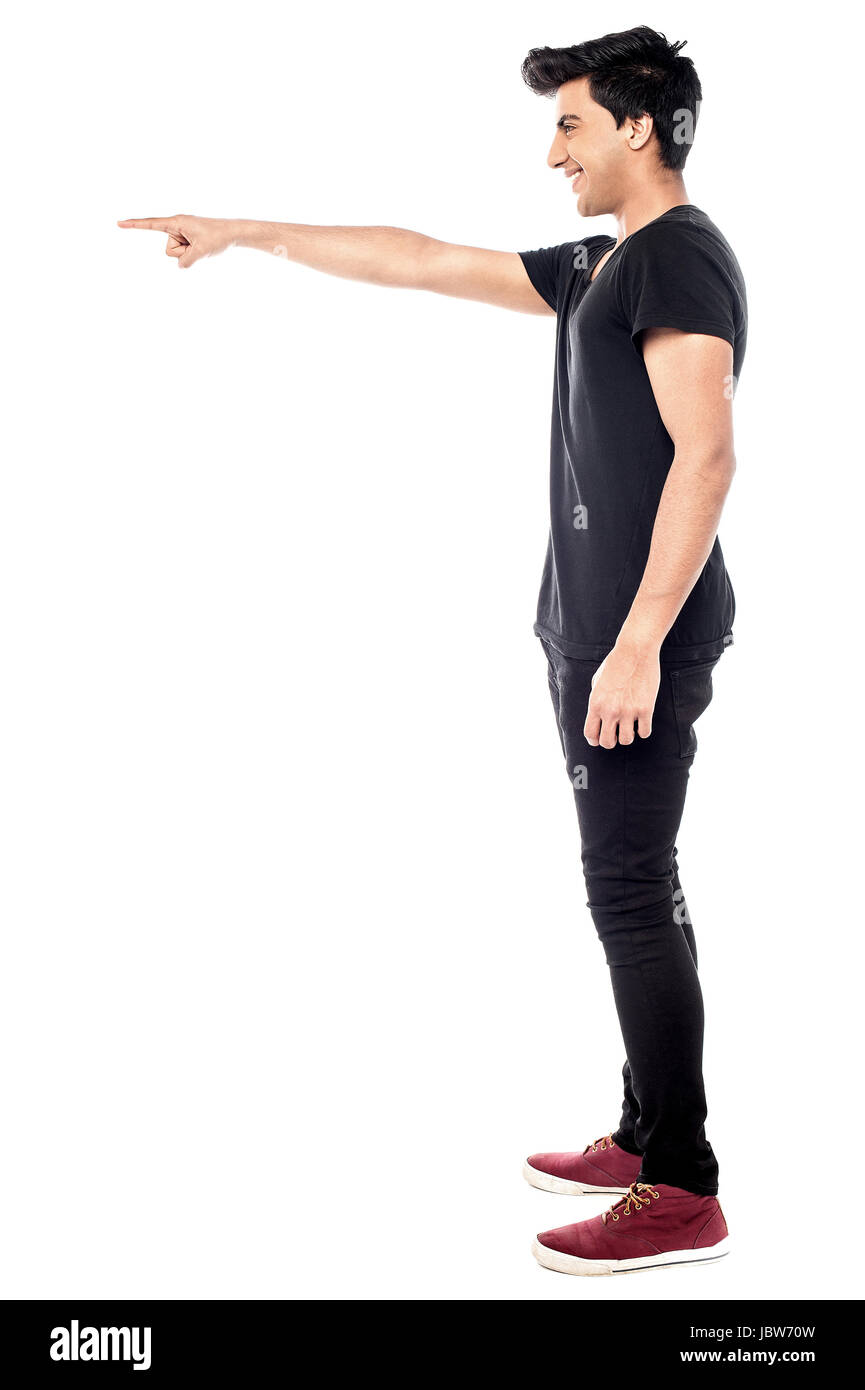Smiling man standing and pointing at something Stock Photo - Alamy