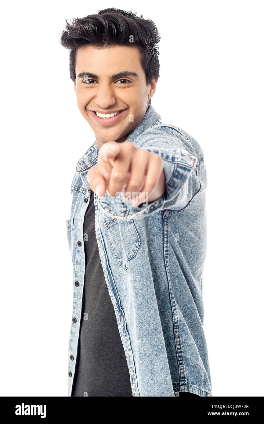 Smiling young man pointing with his finger Stock Photo - Alamy