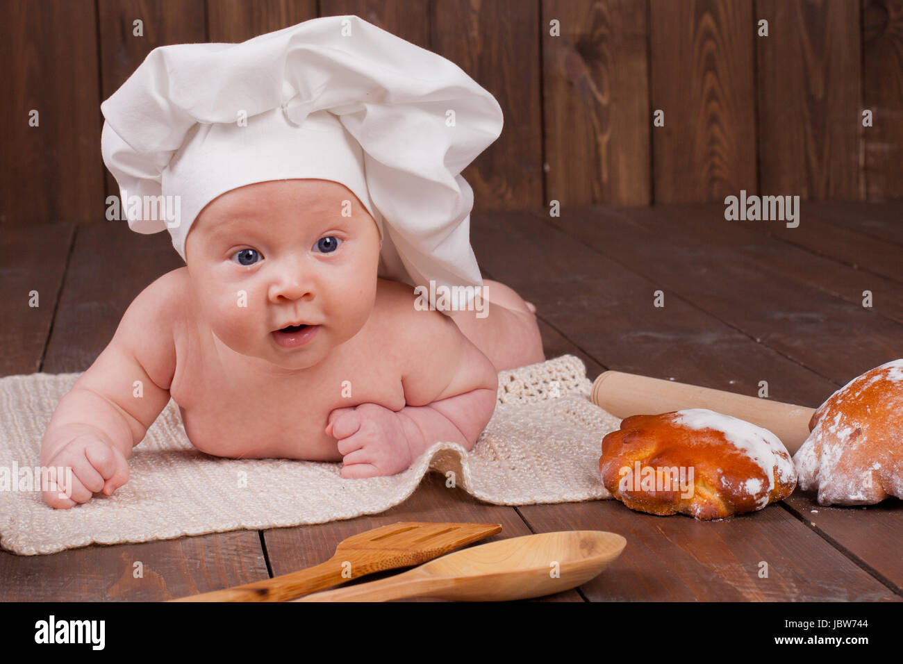 the baby in the head cook flour buns bread Stock Photo - Alamy