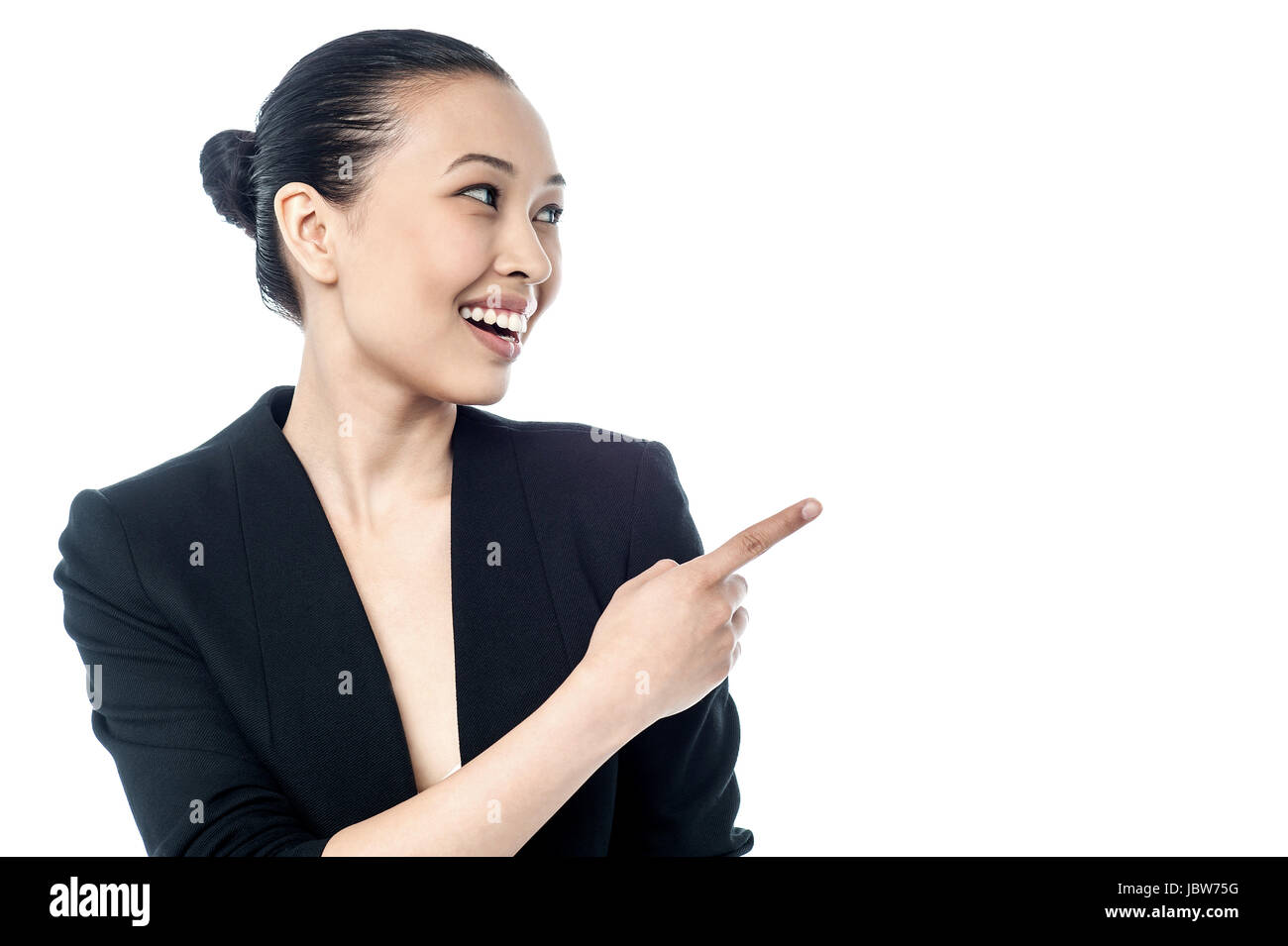 Attractive young woman pointing at something Stock Photo - Alamy
