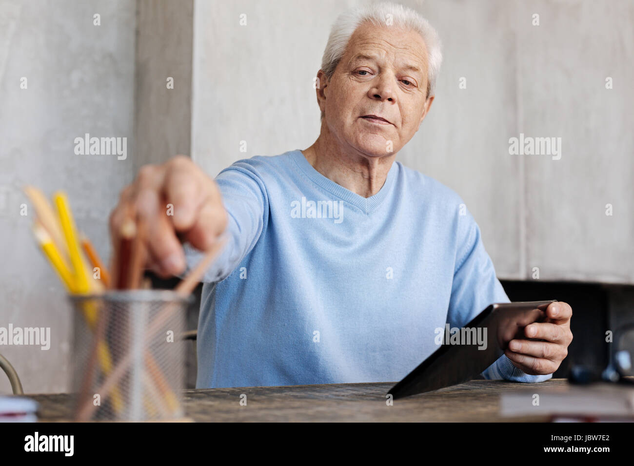 Neat classy writer taking a pencil Stock Photo - Alamy