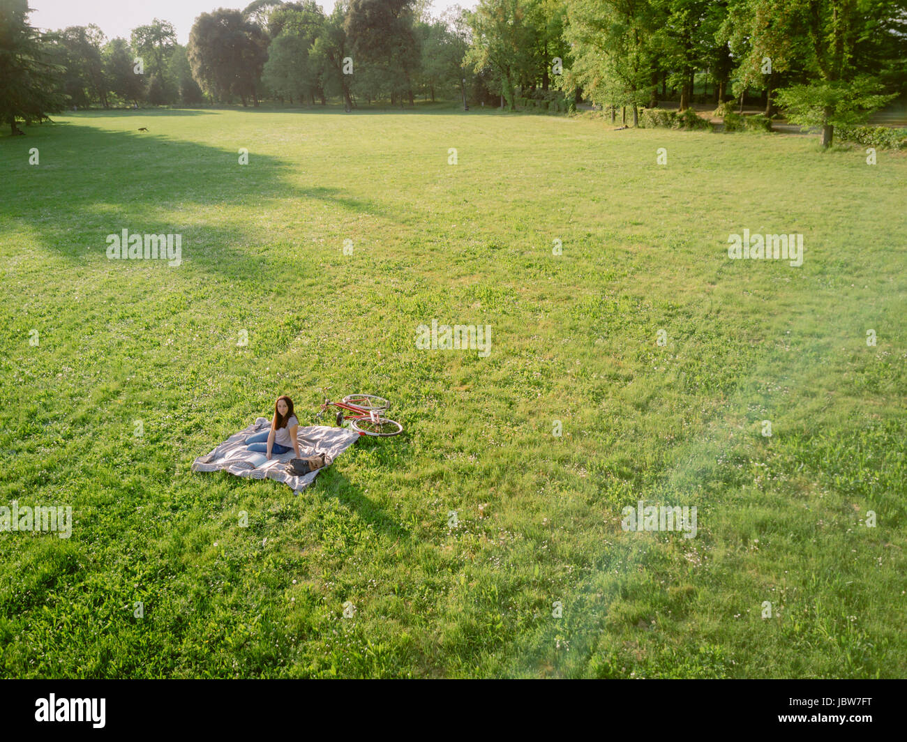 Woman relaxing on grass Stock Photo - Alamy