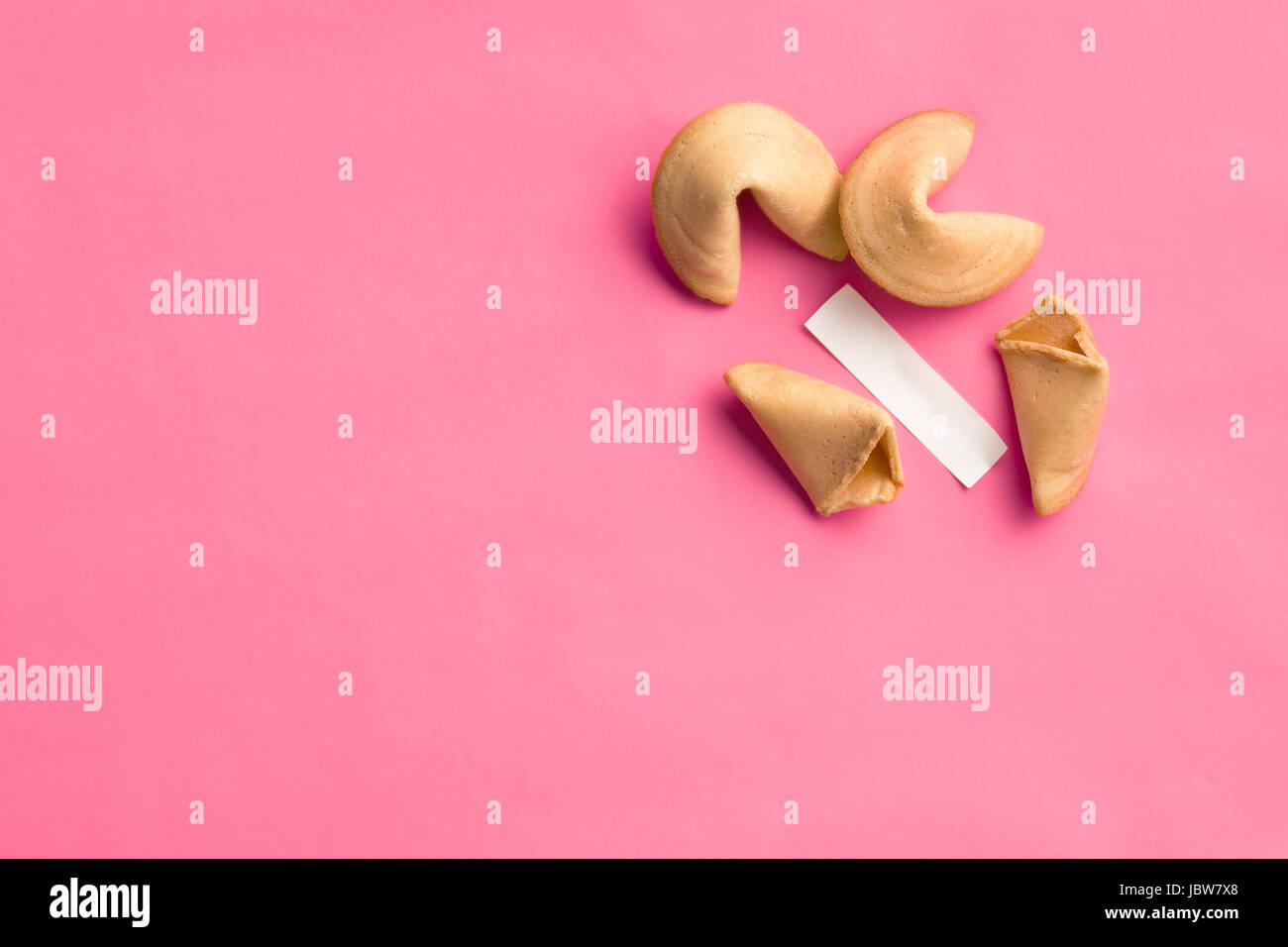 fortune cookies on pink background Stock Photo - Alamy