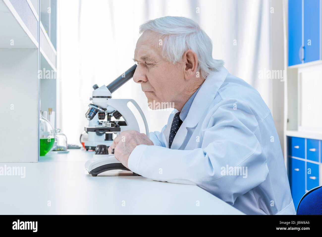 concentrated senior chemists with microscope in laboratory Stock Photo ...