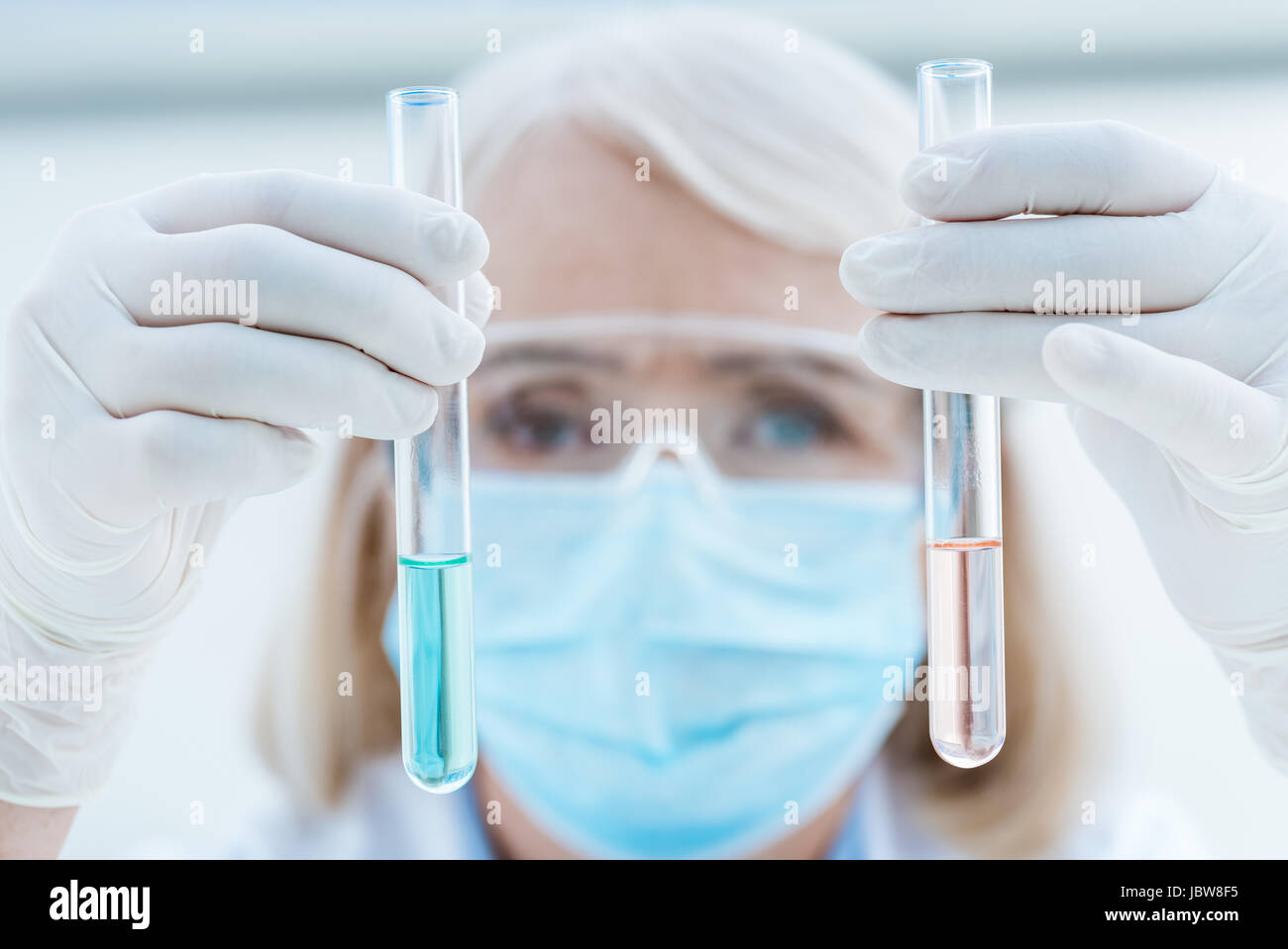 senior chemist looking at test tubes in laboratory Stock Photo - Alamy