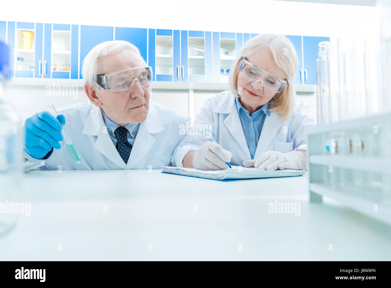 portrait of senior scientists working on experiment in lab Stock Photo ...