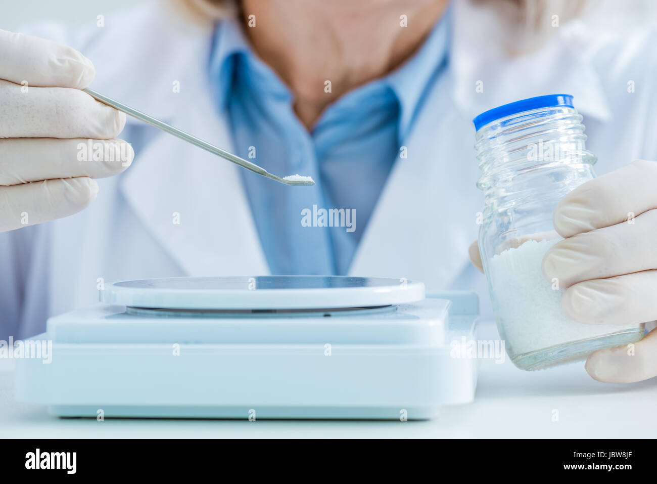 partial view of woman scientist putting reagents on scales in lab Stock ...