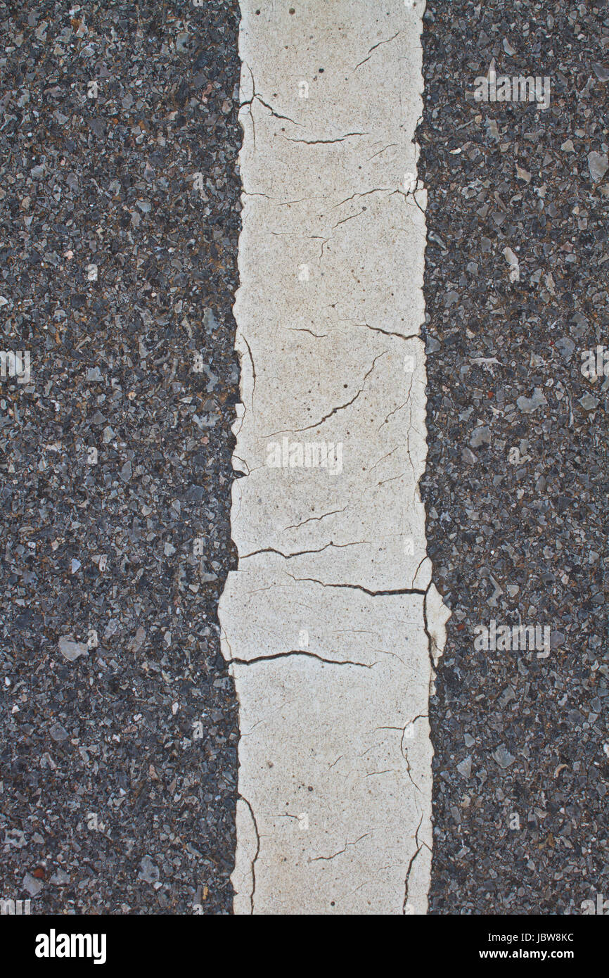 asphalt road with marking lines and tire tracks. Close up photo with ...