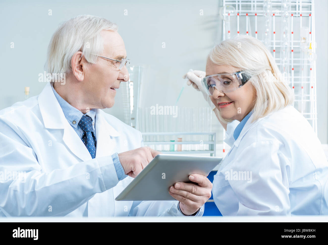 Senior couple of scientists working with digital tablet in lab Stock ...