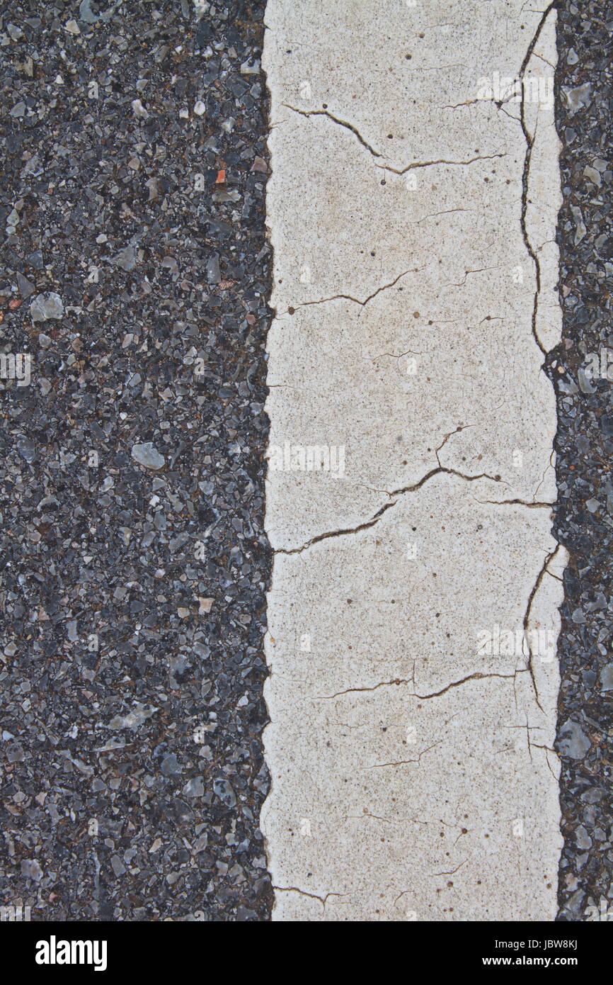 asphalt road with marking lines and tire tracks. Close up photo with ...