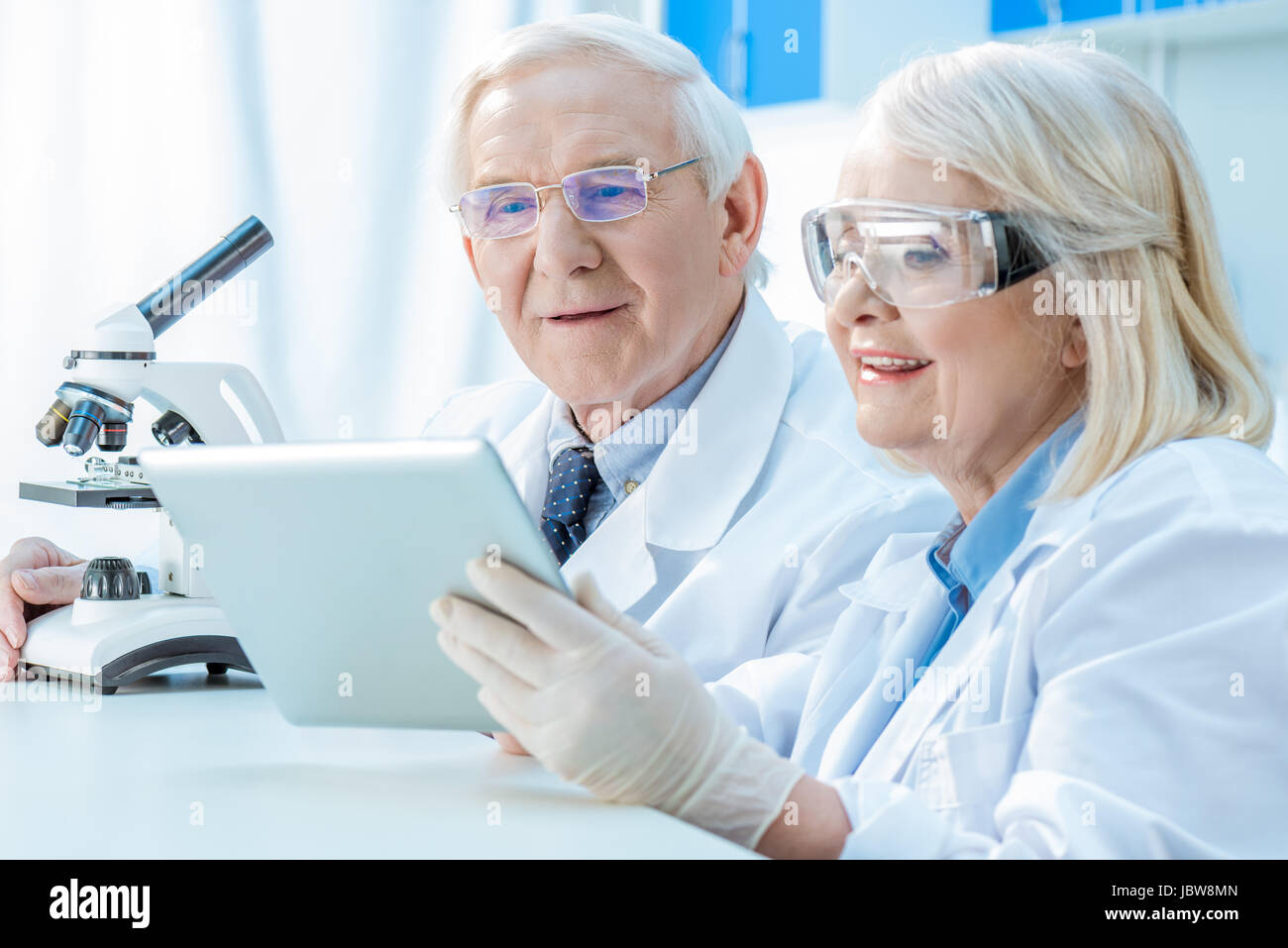 Scientists working using microscope hi-res stock photography and images ...