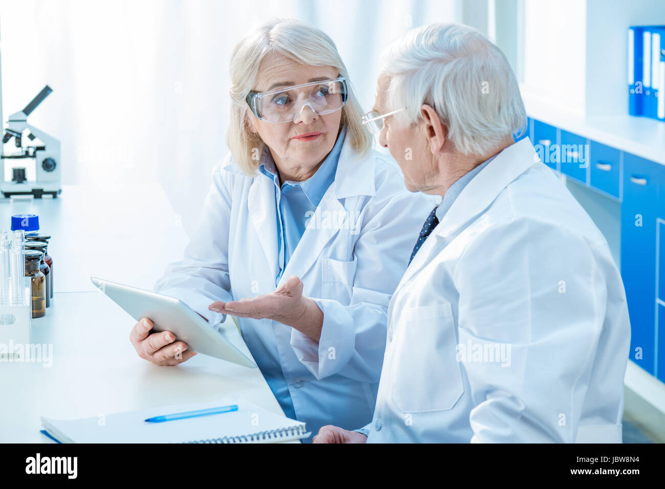 Scientists couple using microscope hi-res stock photography and images ...