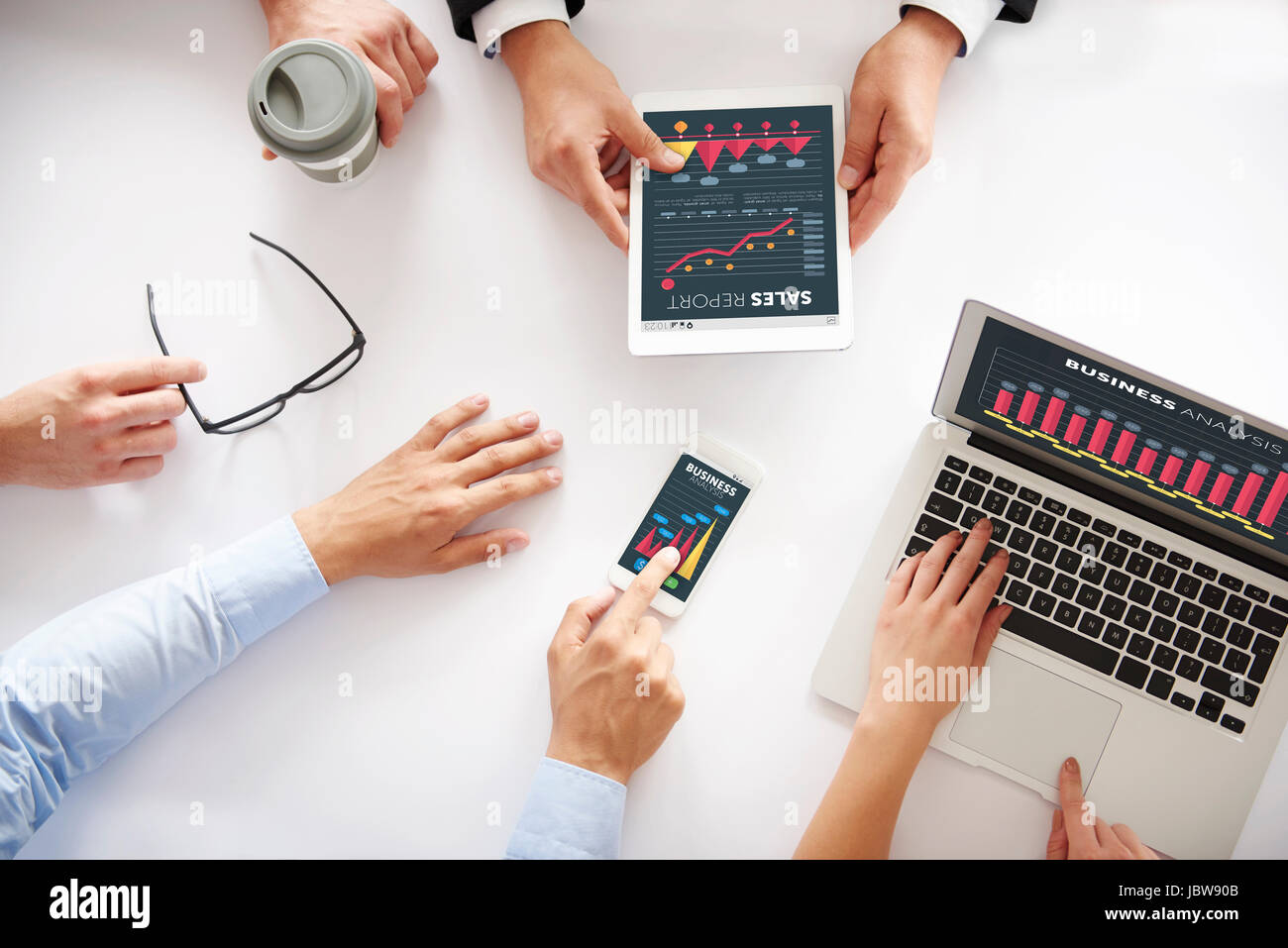 Digital devices on white desk Stock Photo - Alamy