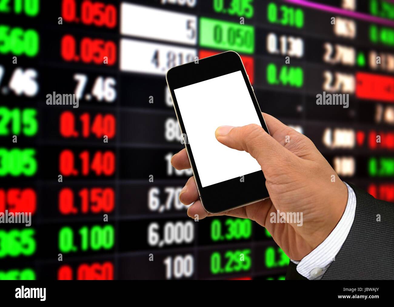 Hand Holding Smart Phone and Stock Data Stock Photo - Alamy