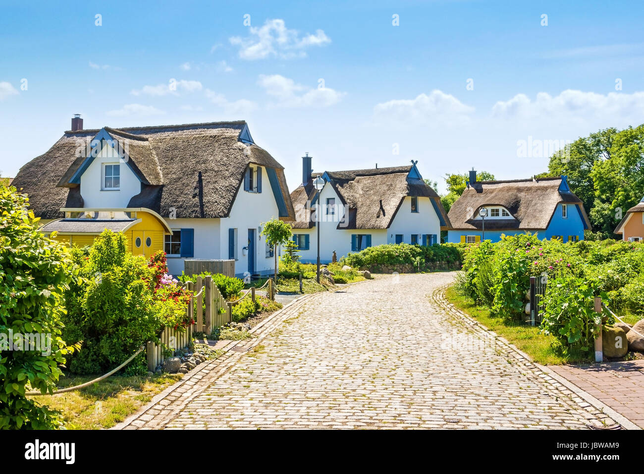 thatched-roof house settlement with cobbled stone street Stock Photo ...