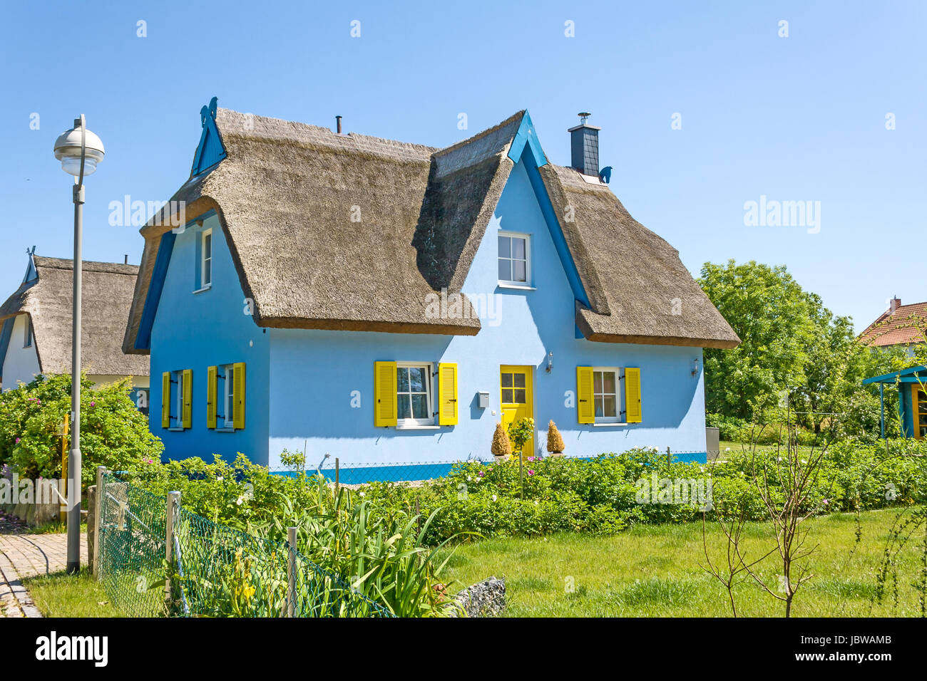 light-blue thatched-roof house with garden Stock Photo - Alamy