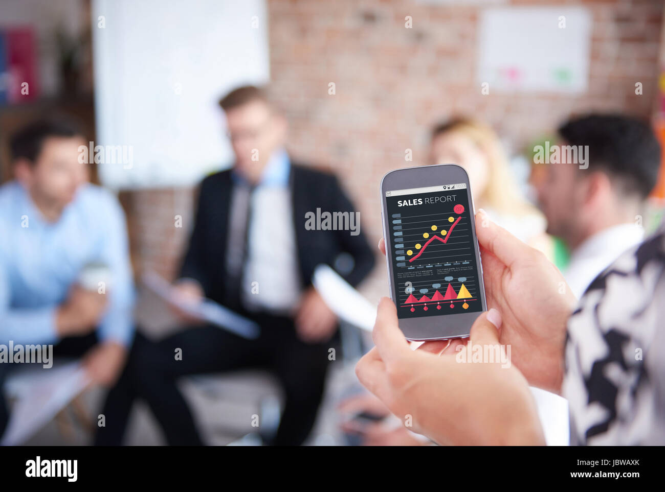 Reading sales report on mobile phone Stock Photo - Alamy