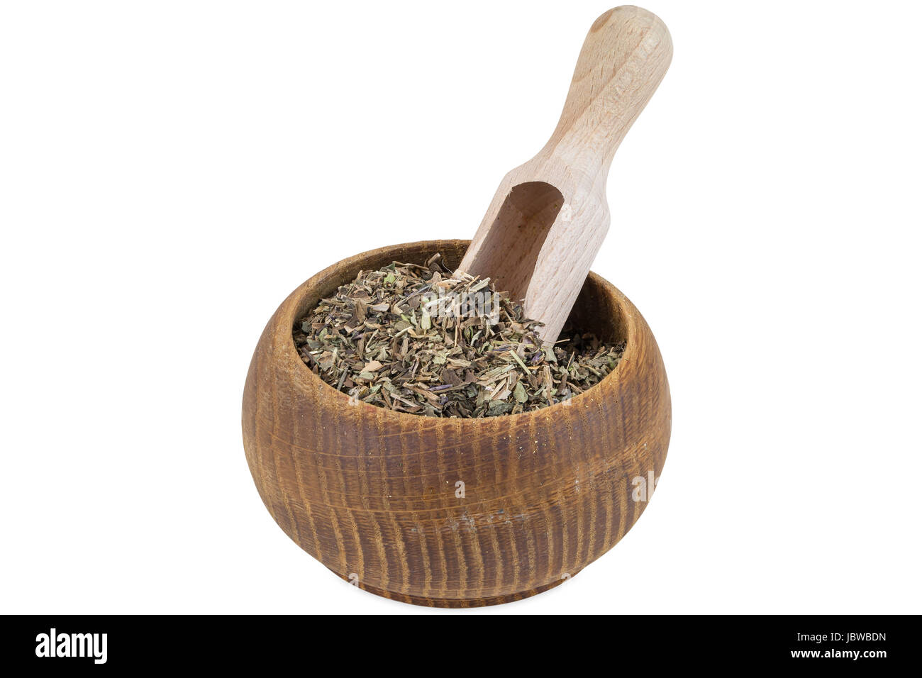 Portion of basil spice in wooden bowl isolated on white background with ...