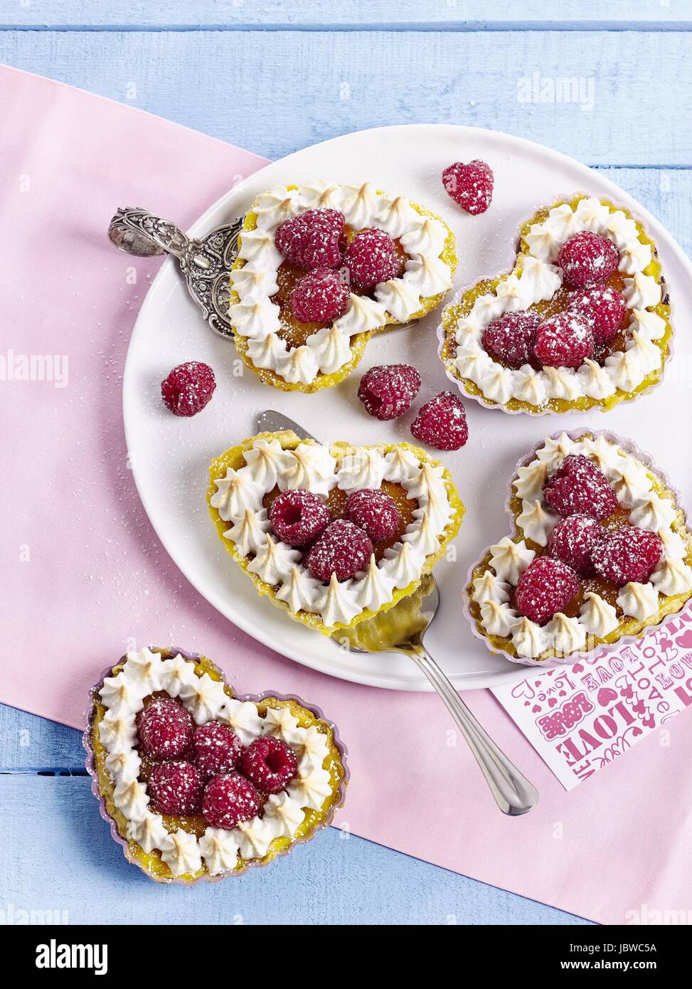 Lemon cake hearts with raspberries and meringue Stock Photo - Alamy