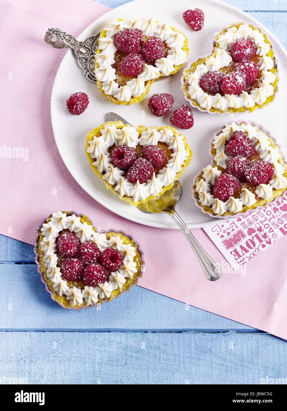 Lemon cake hearts with raspberries and meringue Stock Photo - Alamy