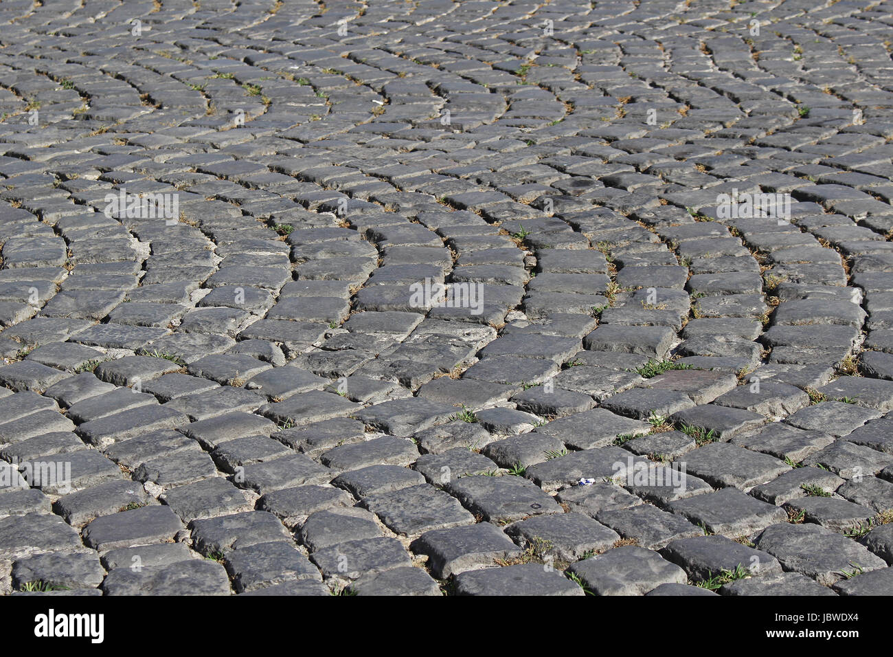 Detail of cobblestone road texture with small tiles Stock Photo - Alamy