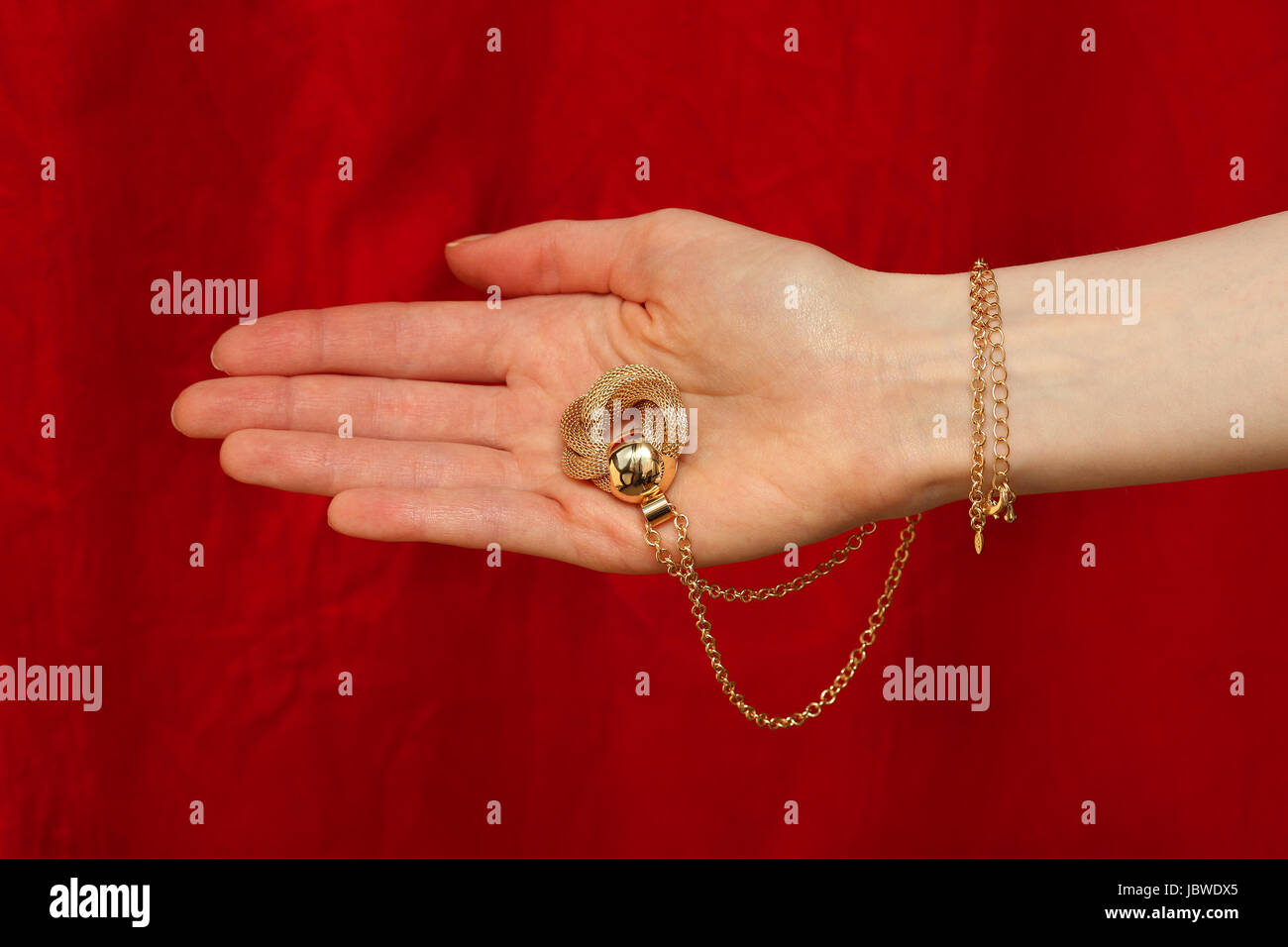 Luxury gold pendant chain in female hand Stock Photo - Alamy