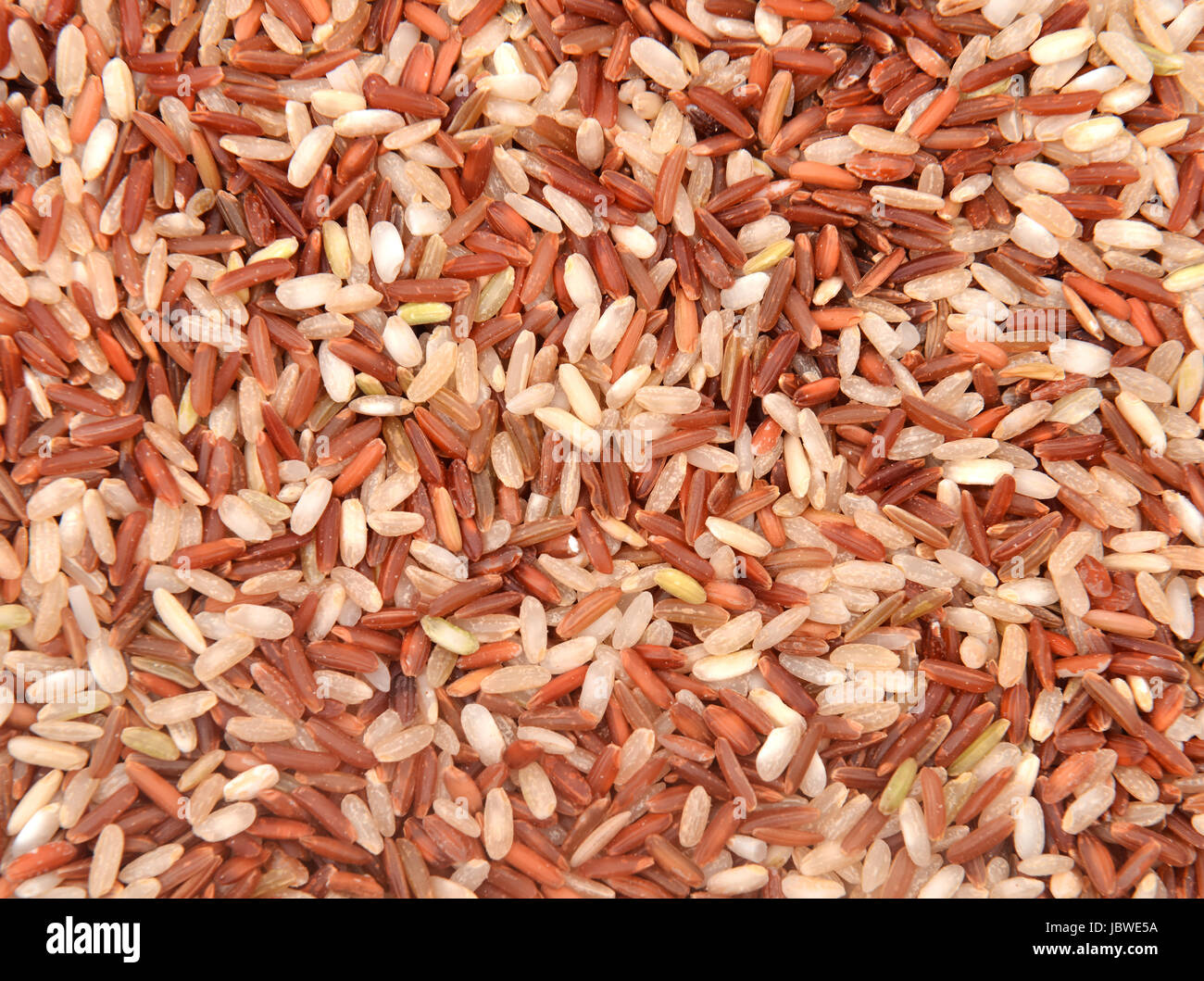 group of milled rice imperfectly cleaned Stock Photo - Alamy