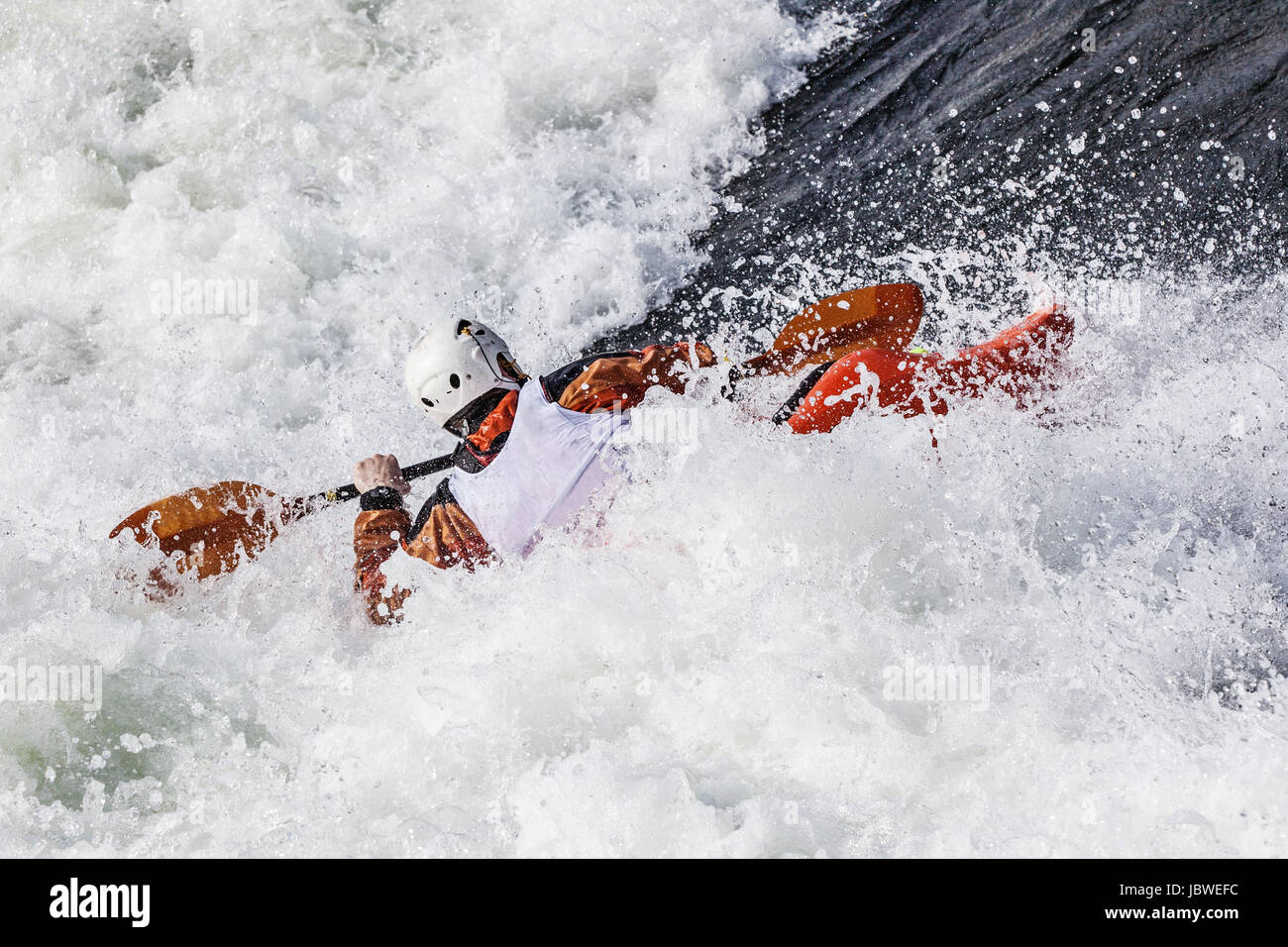 an active male kayaker rolling and surfing in rough water Stock Photo ...