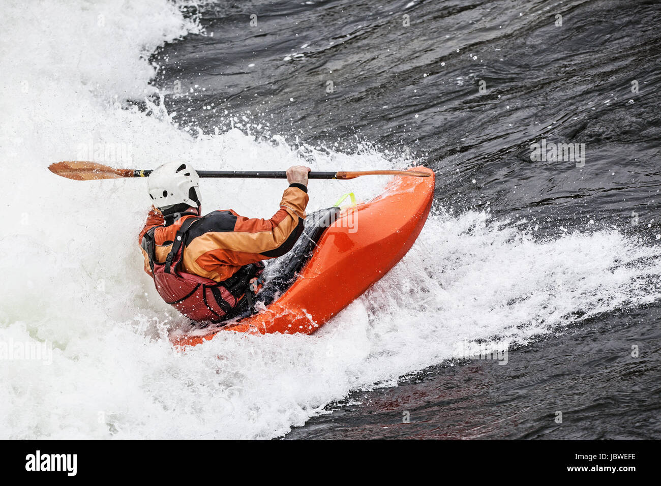 an active male kayaker rolling and surfing in rough water Stock Photo ...