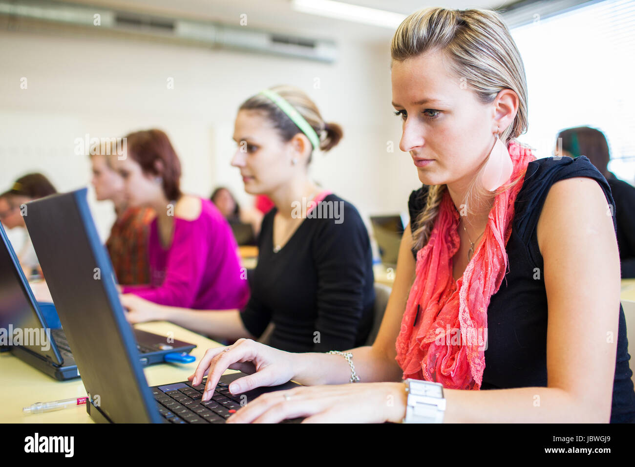 Group of college/university students in in a classroom during class ...
