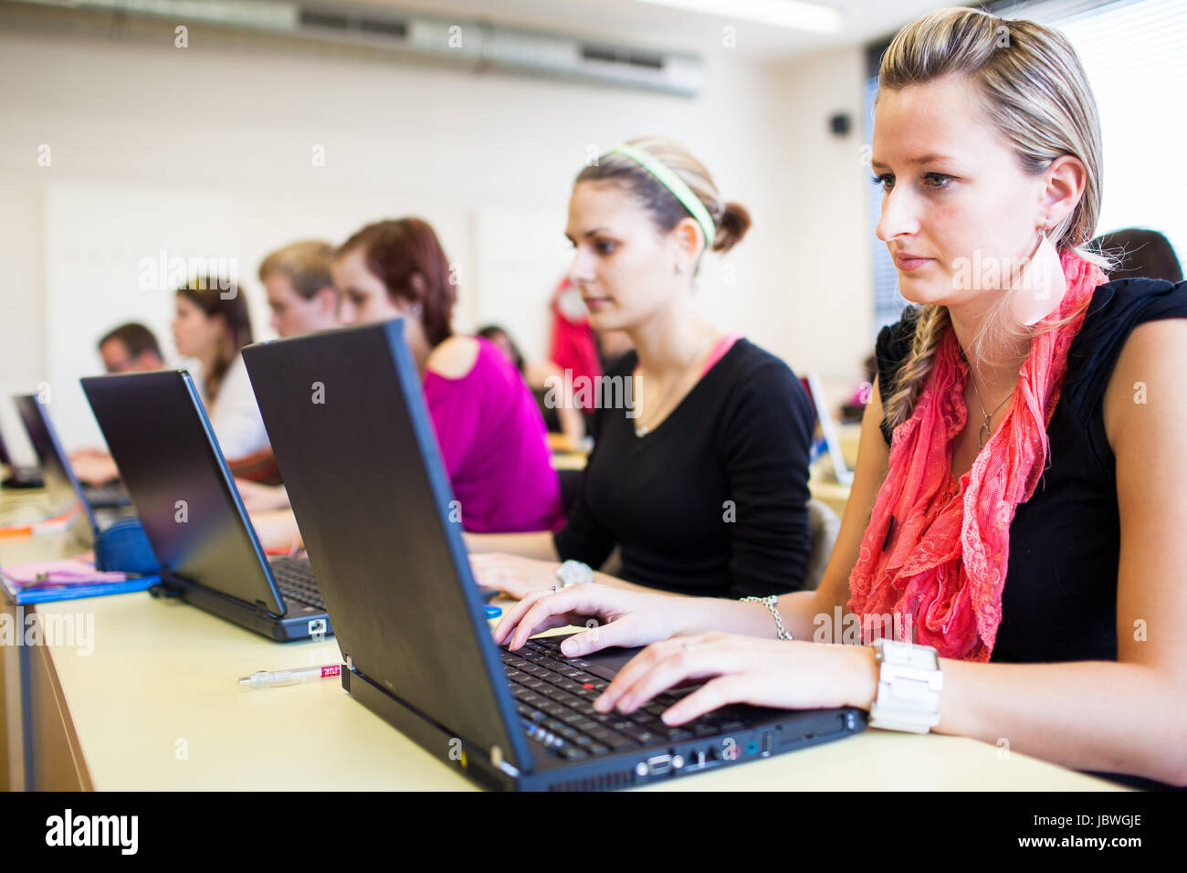 Group of college/university students in in a classroom during class ...