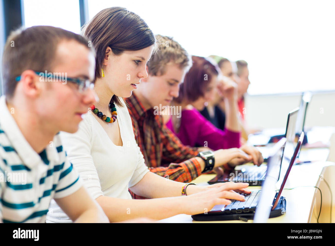 Group of college/university students in in a classroom during class ...