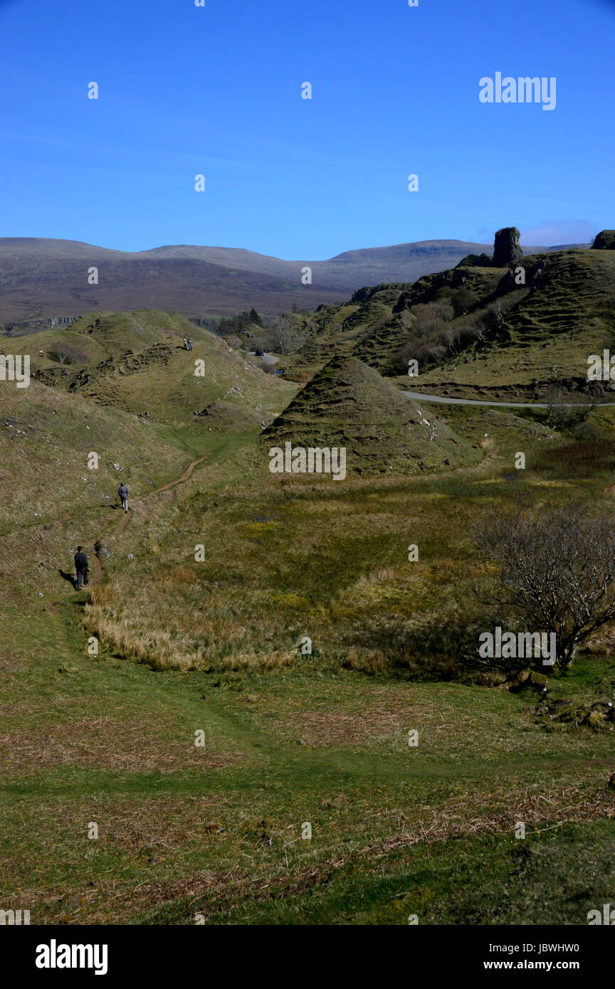 Two People Walking near the Rocky Tower of Castle Ewen & the Cone ...