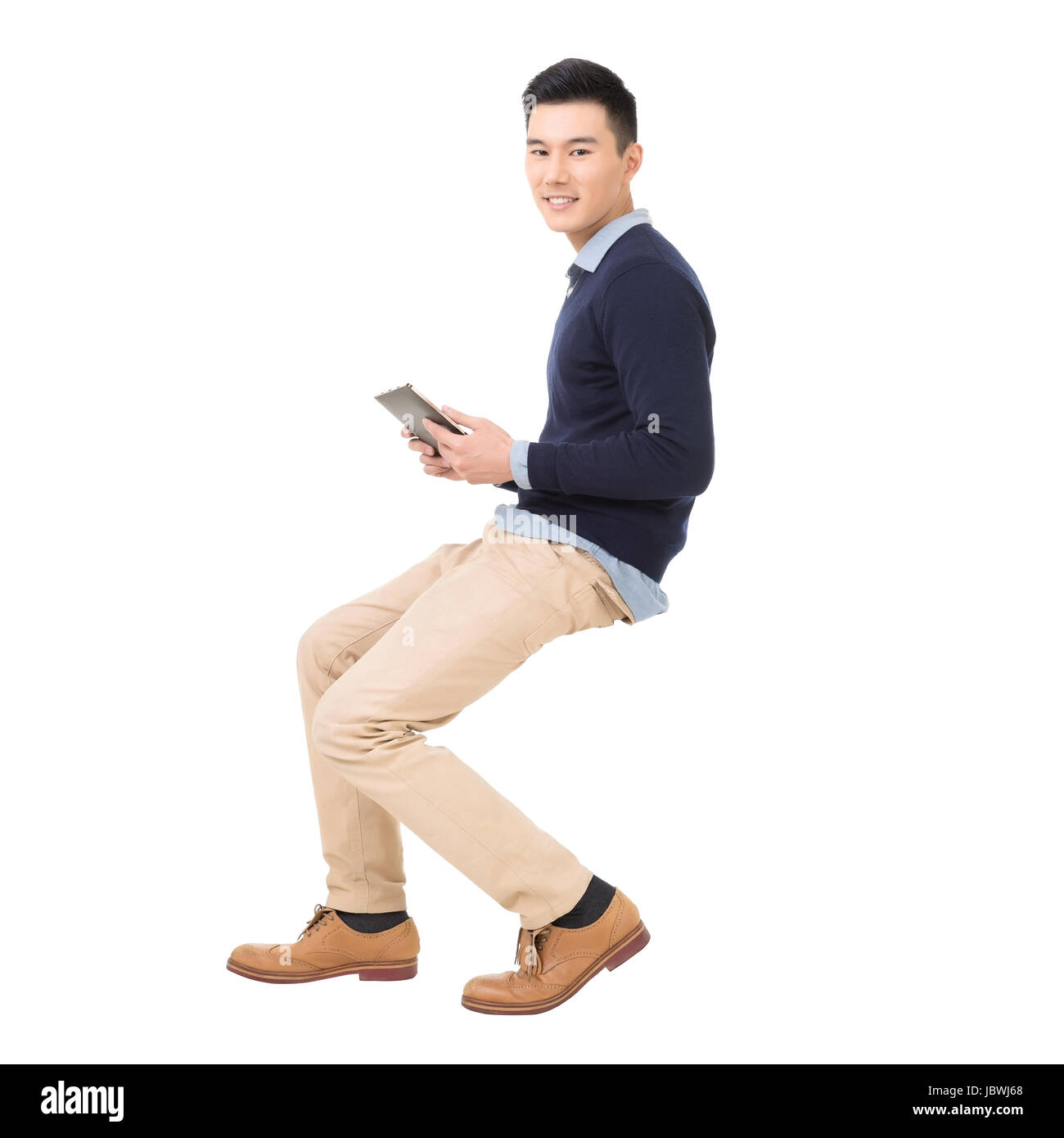 Handsome Asian guy sit and use pad, full length portrait isolated on ...
