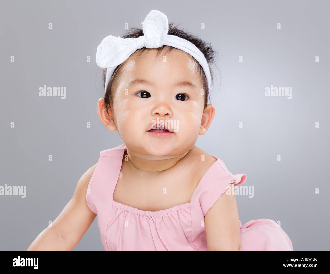 Baby girl making funny face Stock Photo - Alamy