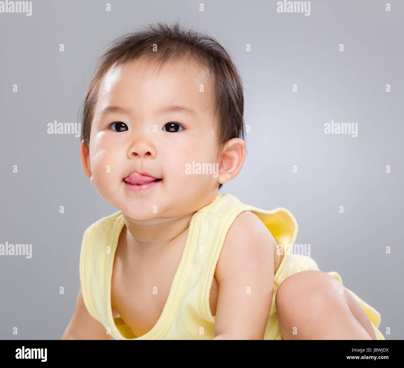 Baby showing naughty face Stock Photo - Alamy