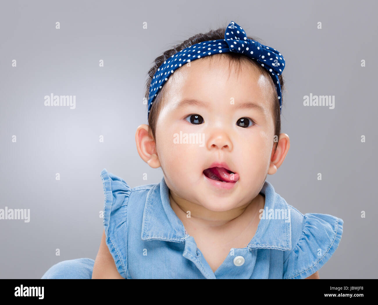 Baby girl feeling hungry Stock Photo - Alamy
