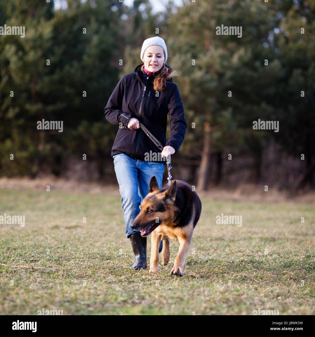 Master and her disobedient (German shepherd) dog Stock Photo - Alamy