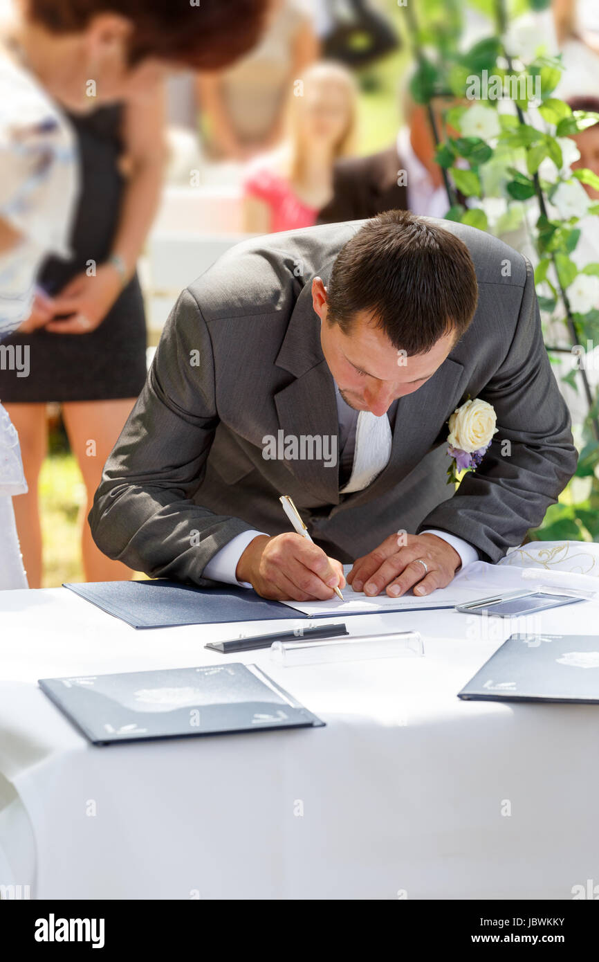 Bride signing document table wedding agreement hi-res stock photography ...