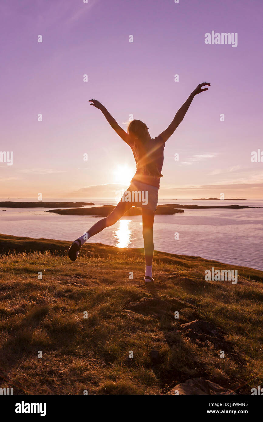 Young girl enjoying life in a beautiful sunset Stock Photo - Alamy