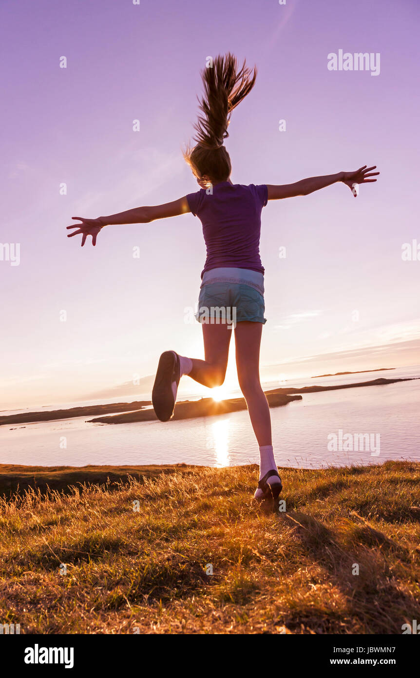 Young girl enjoying life in a beautiful sunset Stock Photo - Alamy